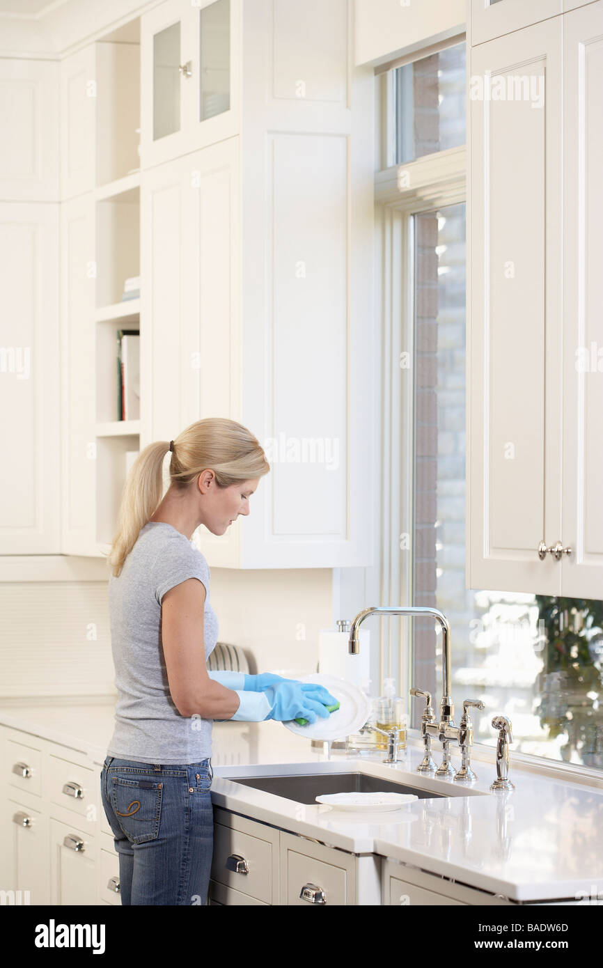 Woman Washing Dishes in Kitchen Stock Photo - Alamy
