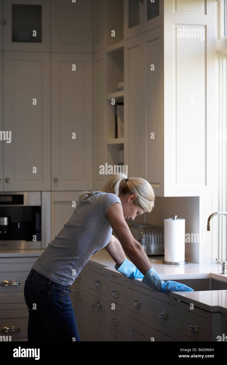 Woman Leaning on Kitchen Sink Stock Photo - Alamy