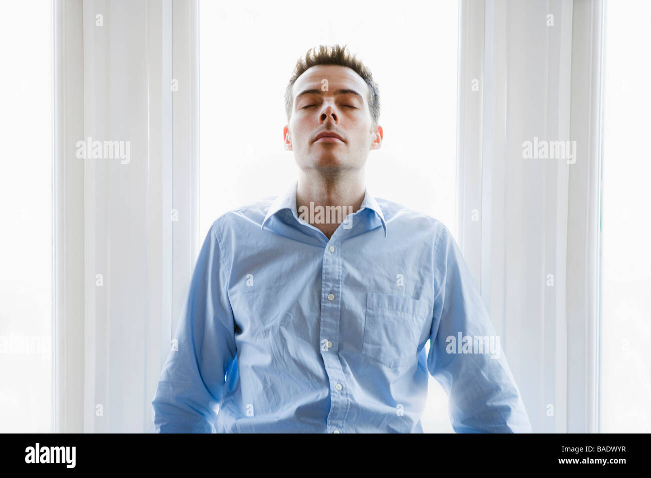 man leaning back on table Stock Photo - Alamy