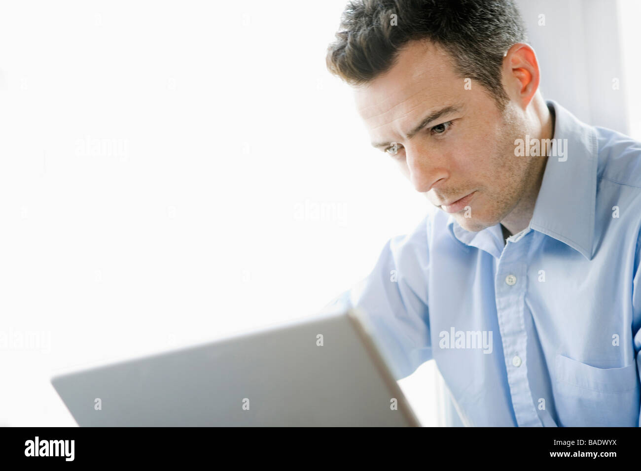 man staring at laptop screen Stock Photo - Alamy