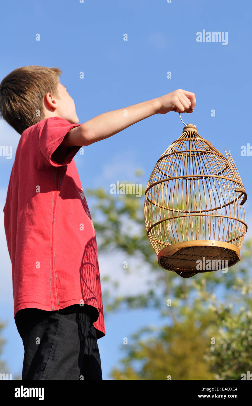 Boy Holding Empty Birdcage Stock Photo - Alamy