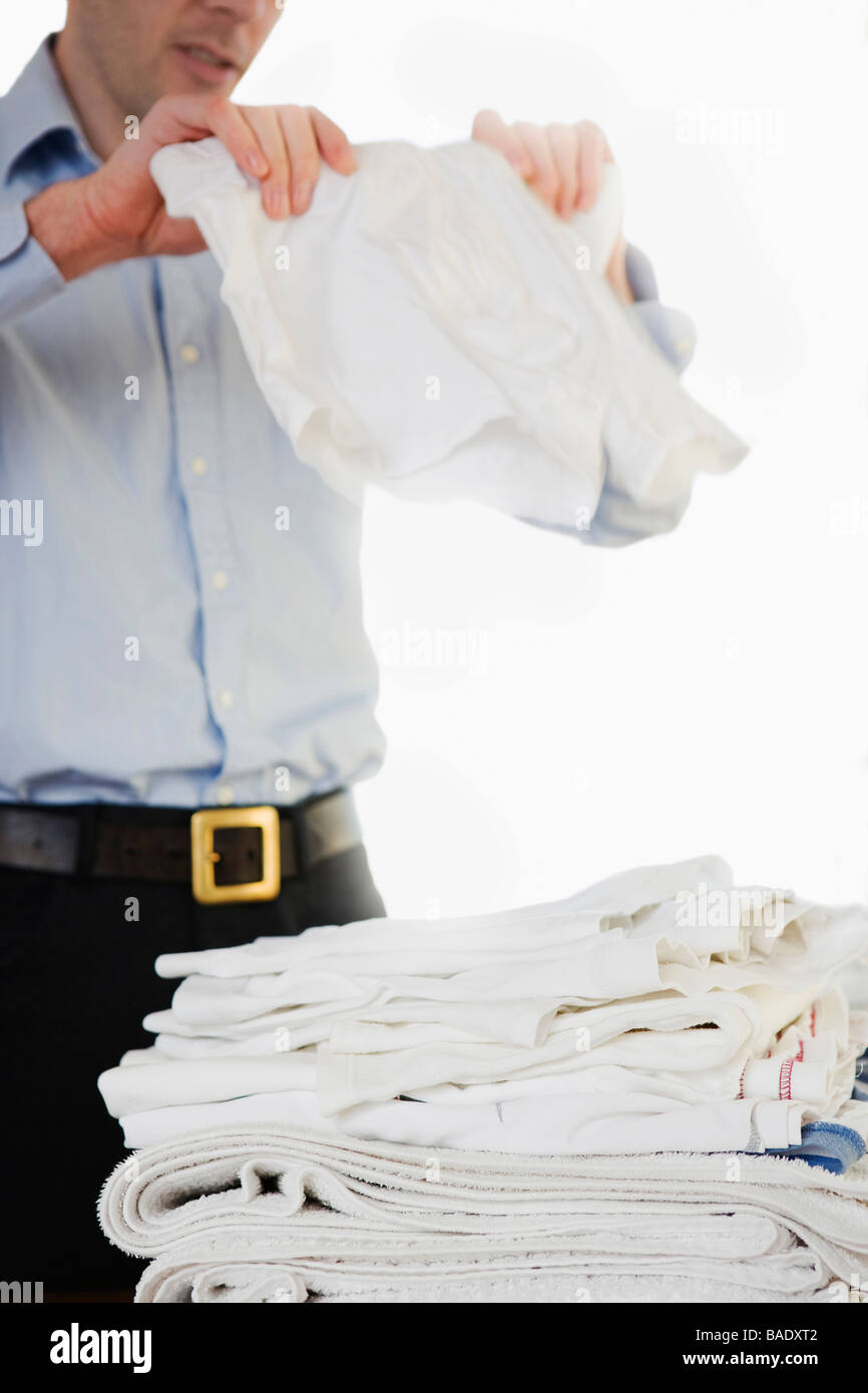 man folding white cloth Stock Photo - Alamy