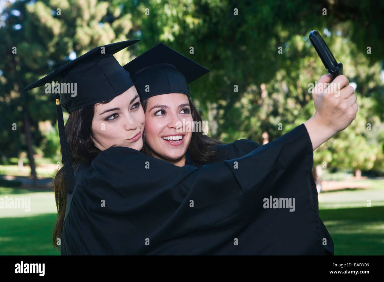 Graduates Taking Self Portrait with Camera Phone Stock Photo - Alamy