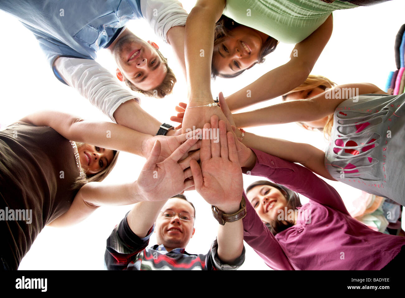 group of happy friends smiling with hands together Stock Photo - Alamy