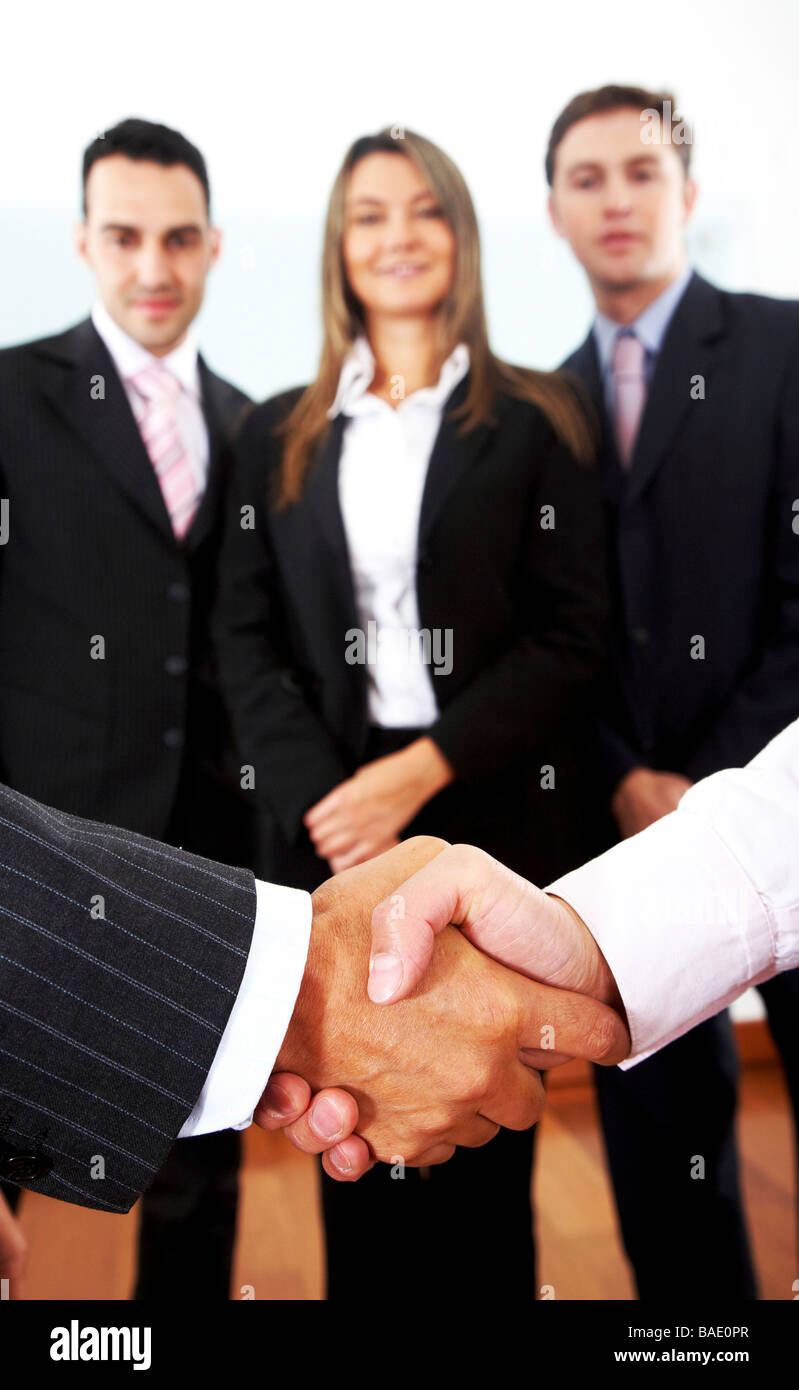 business deal in an office with a team in the background Stock Photo ...