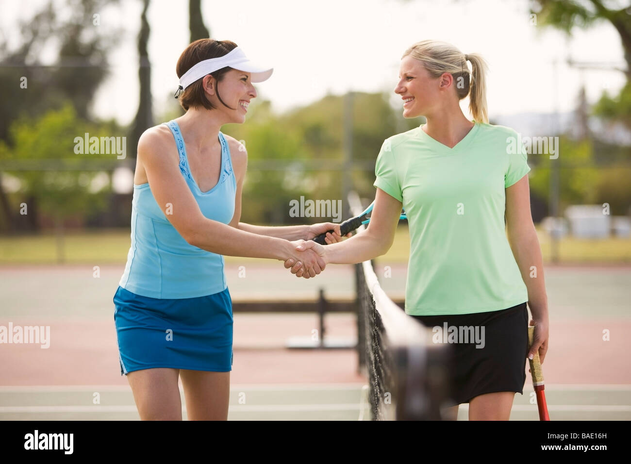Female Tennis Players Shaking Hands Across Net Stock Photo - Alamy