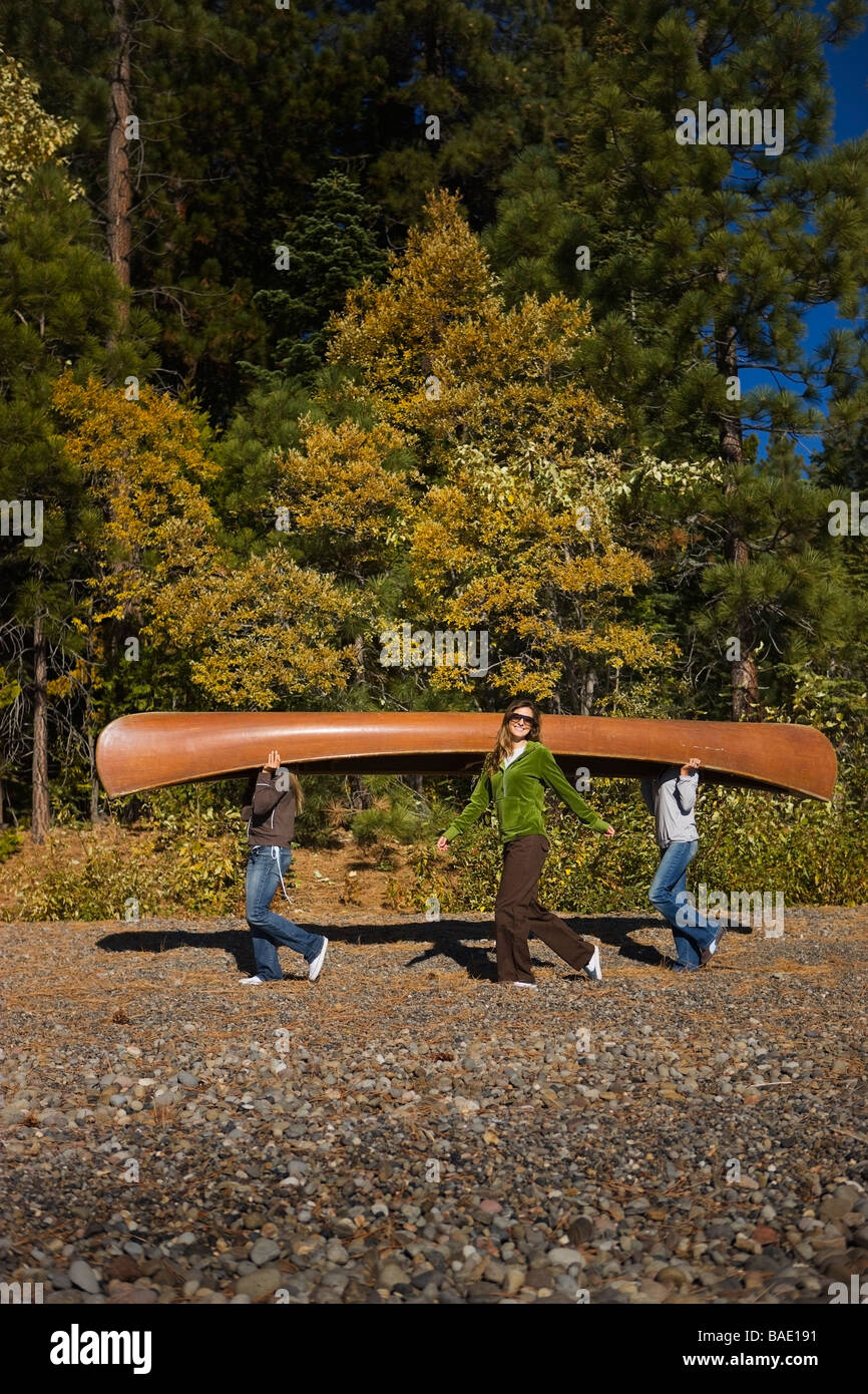Three Women Carrying Canoe in the Forest Stock Photo - Alamy