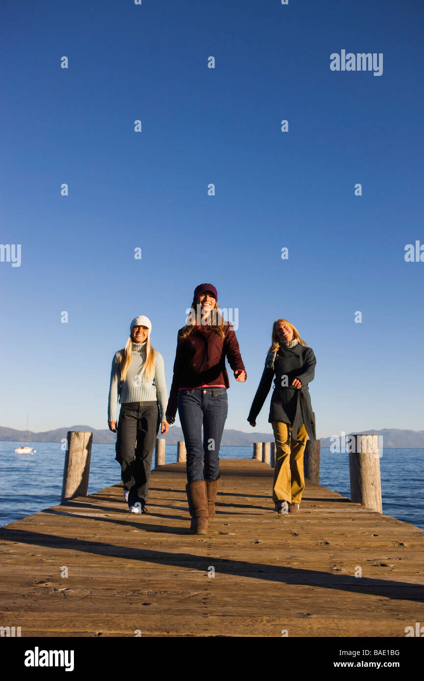 Three Women Walking on Dock Stock Photo - Alamy
