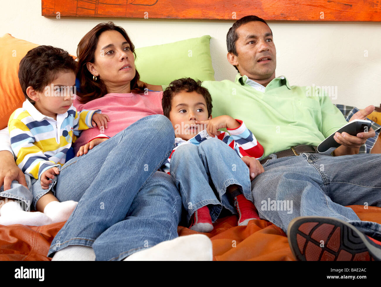 family gathered together watching a movie in their bedroom Stock Photo ...