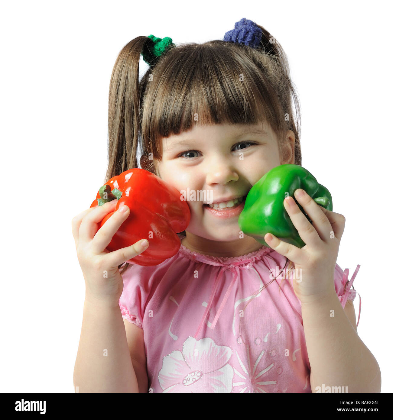 The little girl with color pepper It is isolated on a white background ...