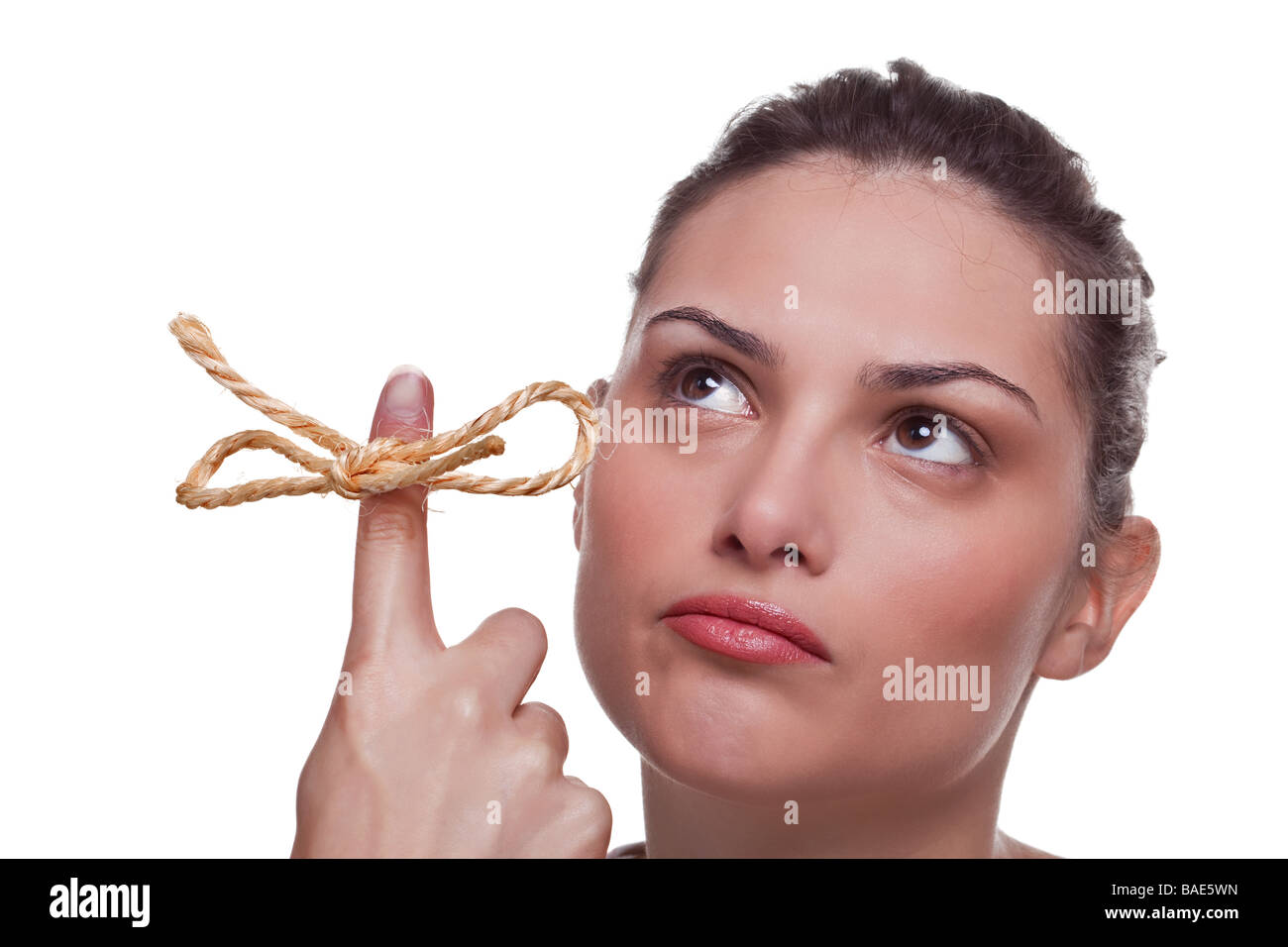 Young woman trying to remember what the piece of string round her ...