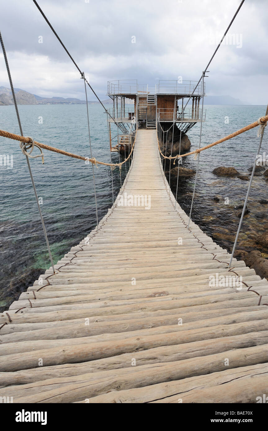The hinged bridge Above the sea to island on which it is located by ...