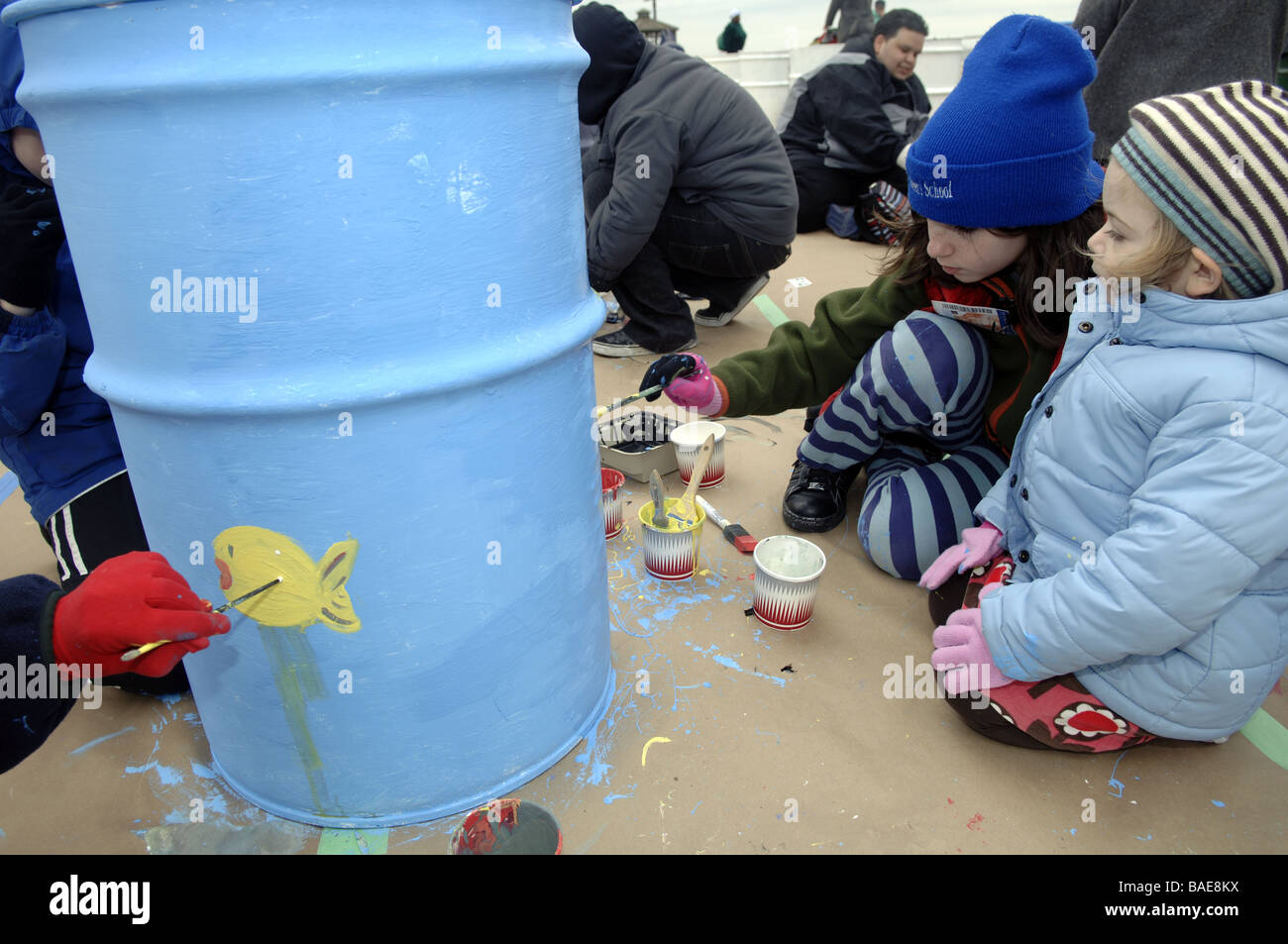 Volunteers participate in Barrels of Fun on the Coney Island boardwalk ...