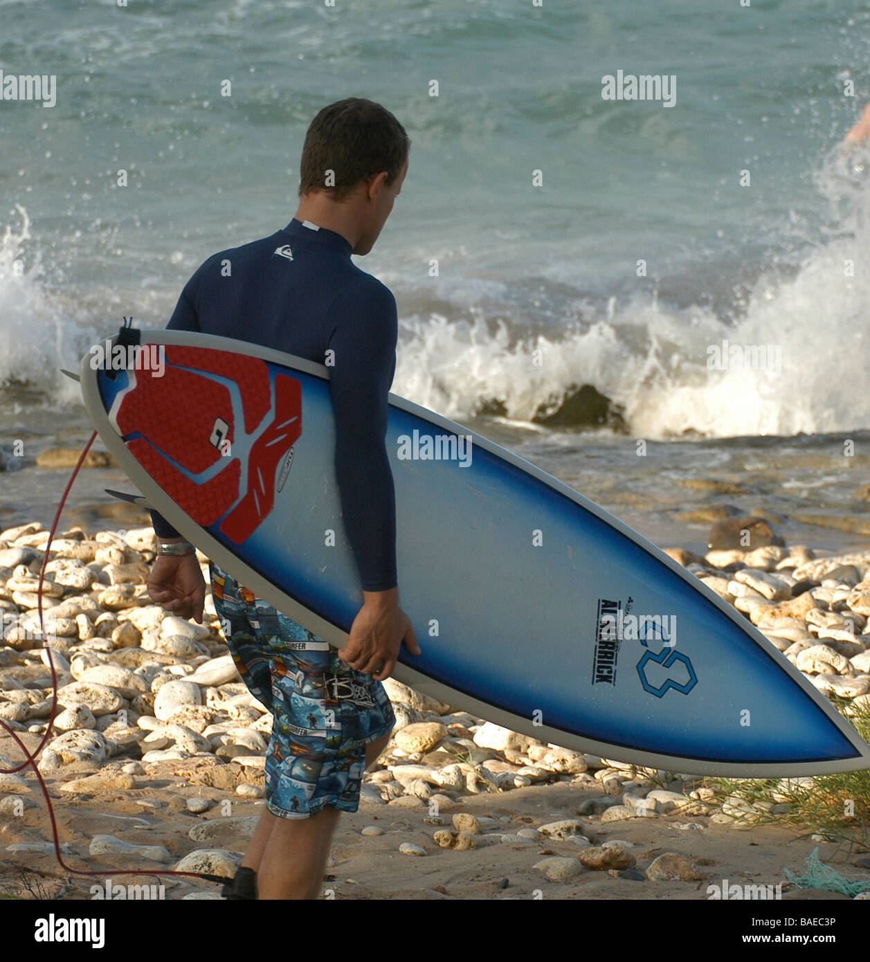 Male surfer prepares to enter the sea to go surfing Stock Photo - Alamy