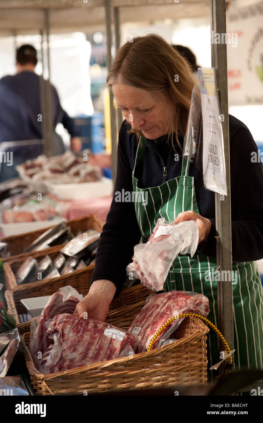 A woman selling organic locally produced welsh meat at Aberystwyth ...