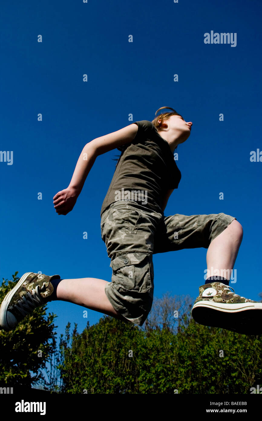 view looking up at young girl running high in the sky Stock Photo - Alamy