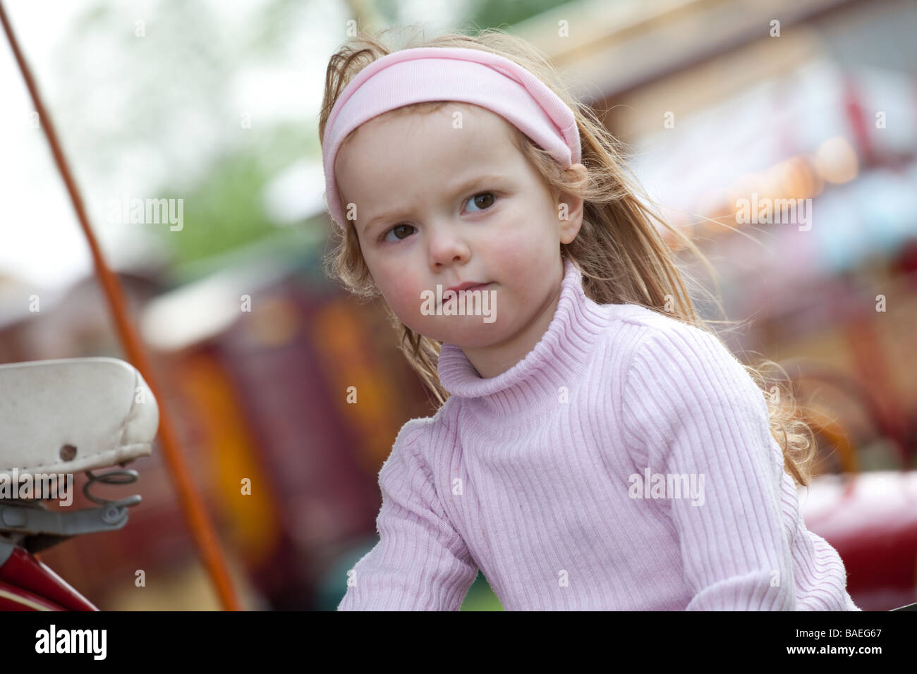 A girl on a ride at the fair Stock Photo - Alamy