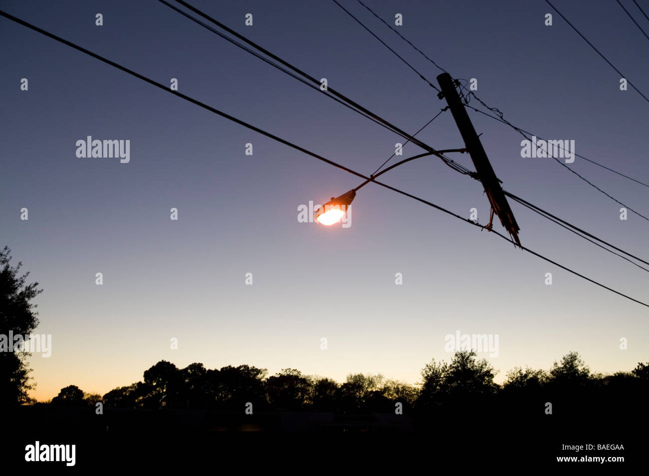 a broken streetlight hangs from power cables still working Stock Photo ...