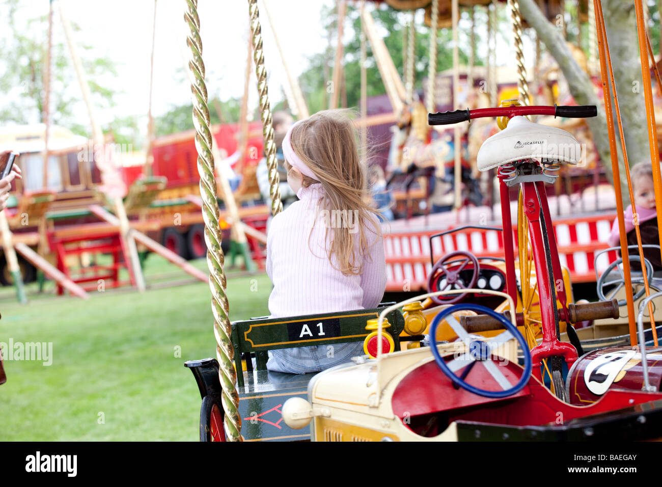 Girl on a ride at the fair Stock Photo - Alamy