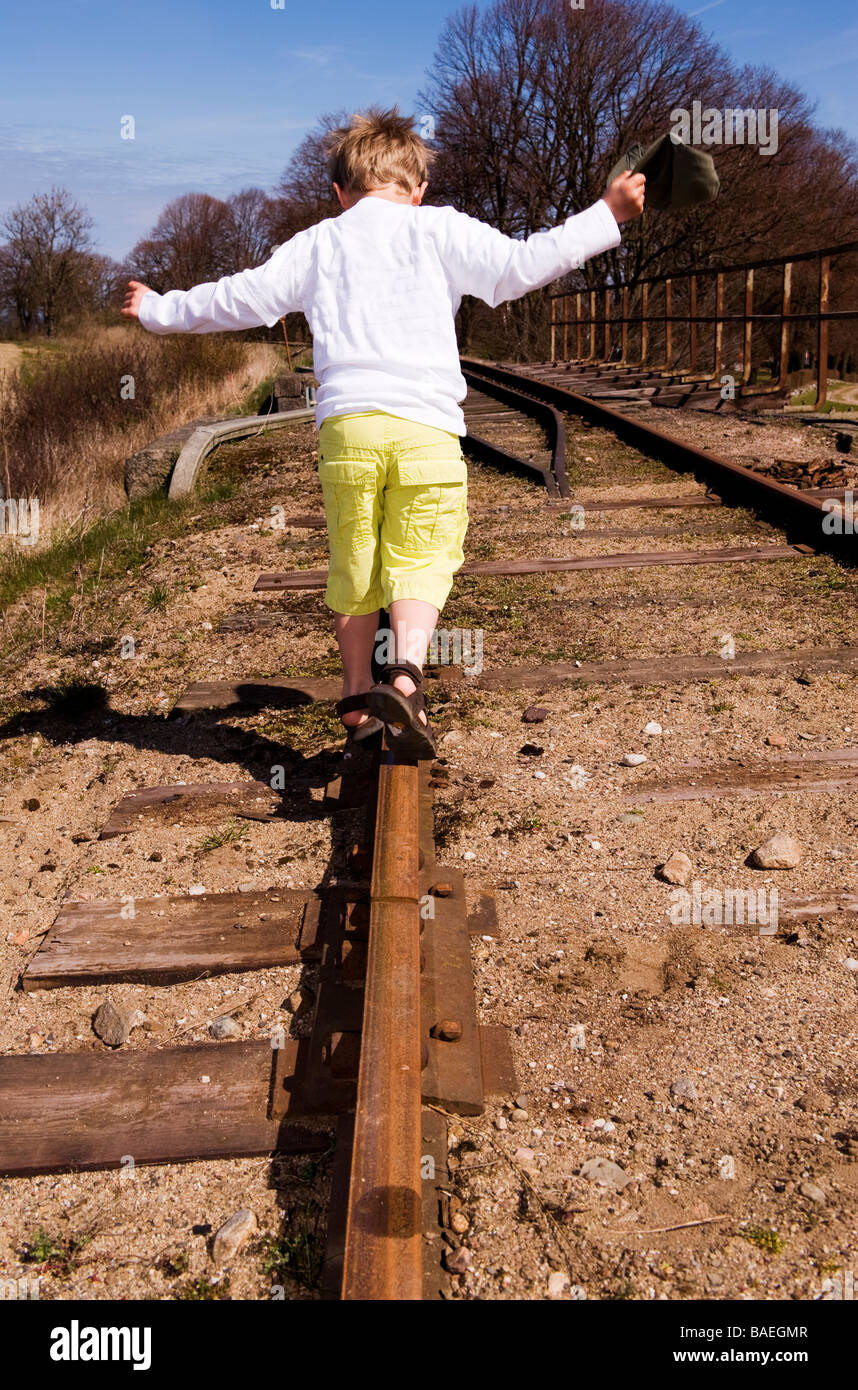 Young boy balancing on railway hi-res stock photography and images - Alamy