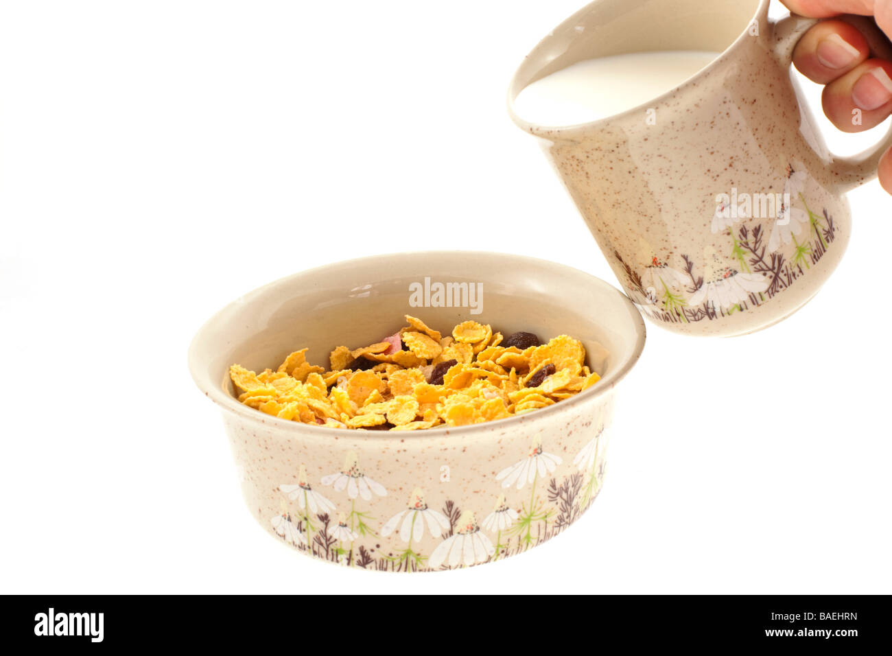 cornflakes and a hand with cup of milk on a white background Stock ...