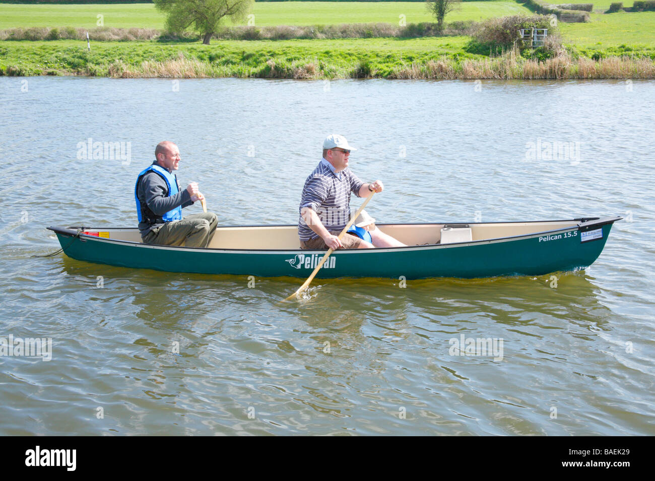 Canadian type canoe with occupants paddling Stock Photo - Alamy
