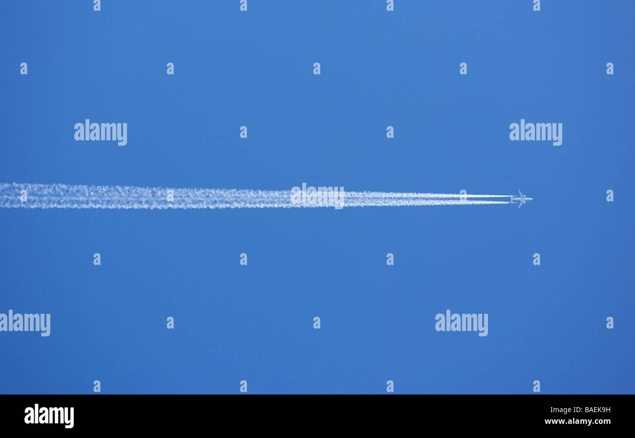 A jet passenger aircraft flying at high altitude with Contrails visible ...