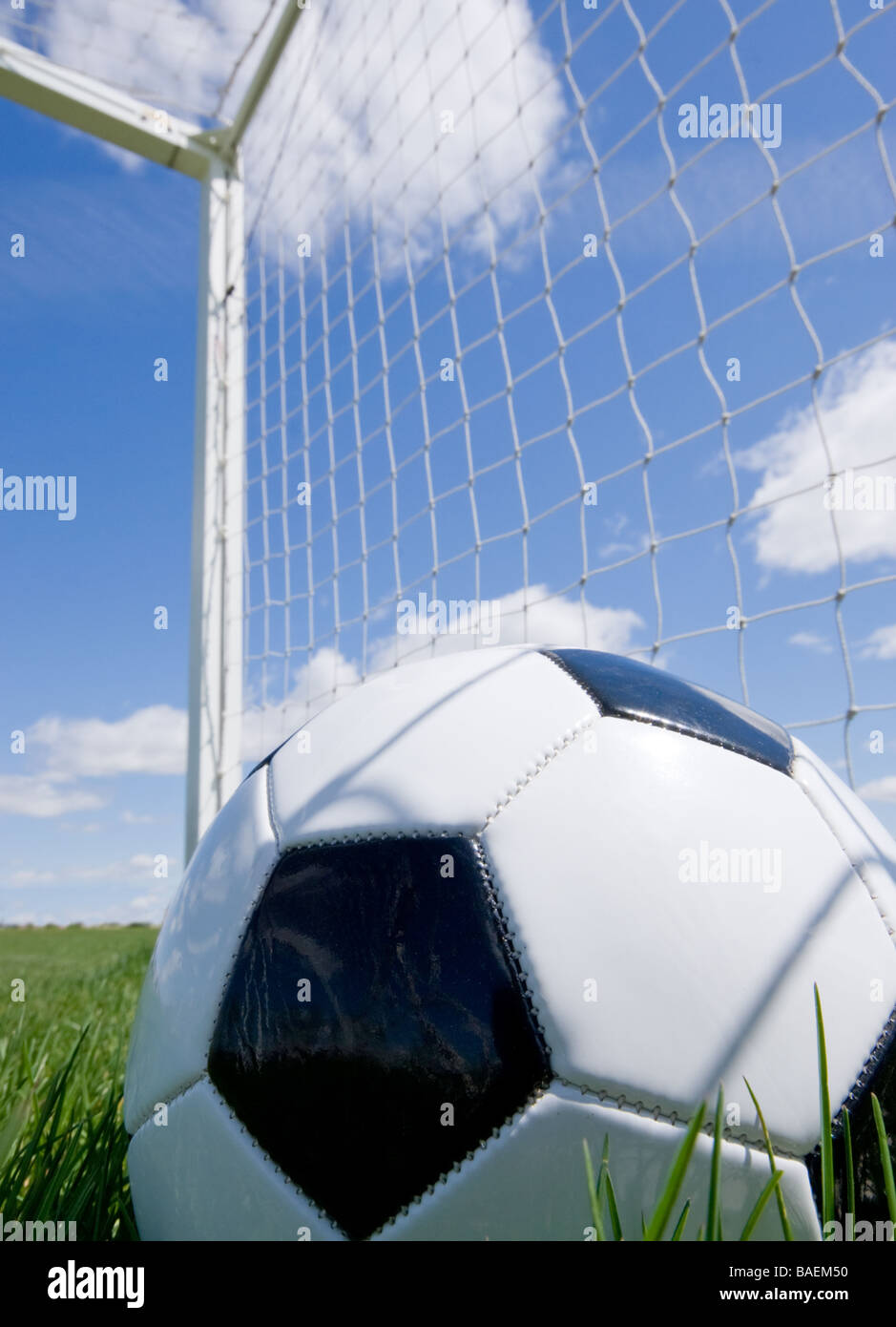Soccer ball in goal netand blue sky Stock Photo - Alamy