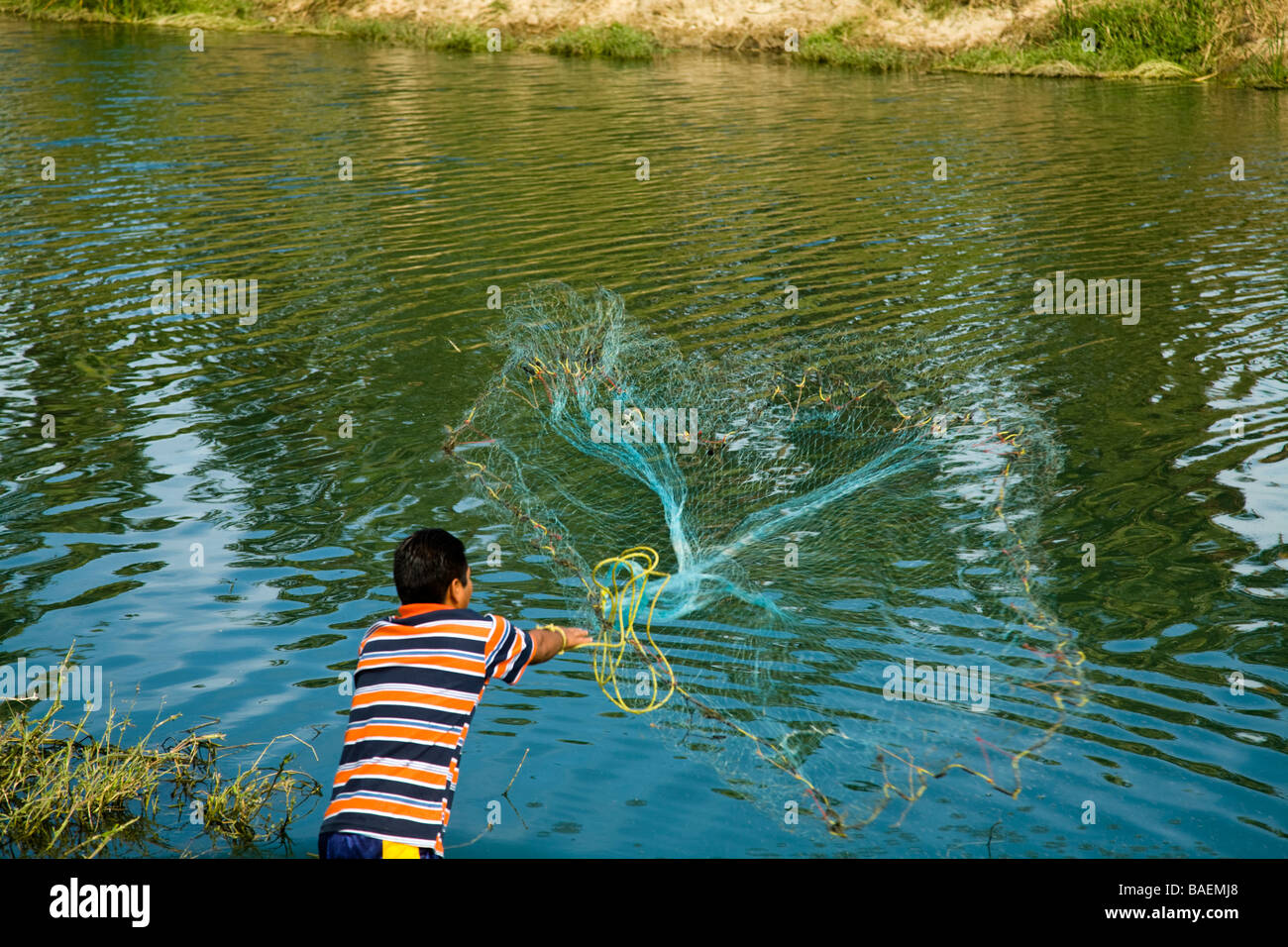 Man throwing fishing net hi-res stock photography and images - Alamy