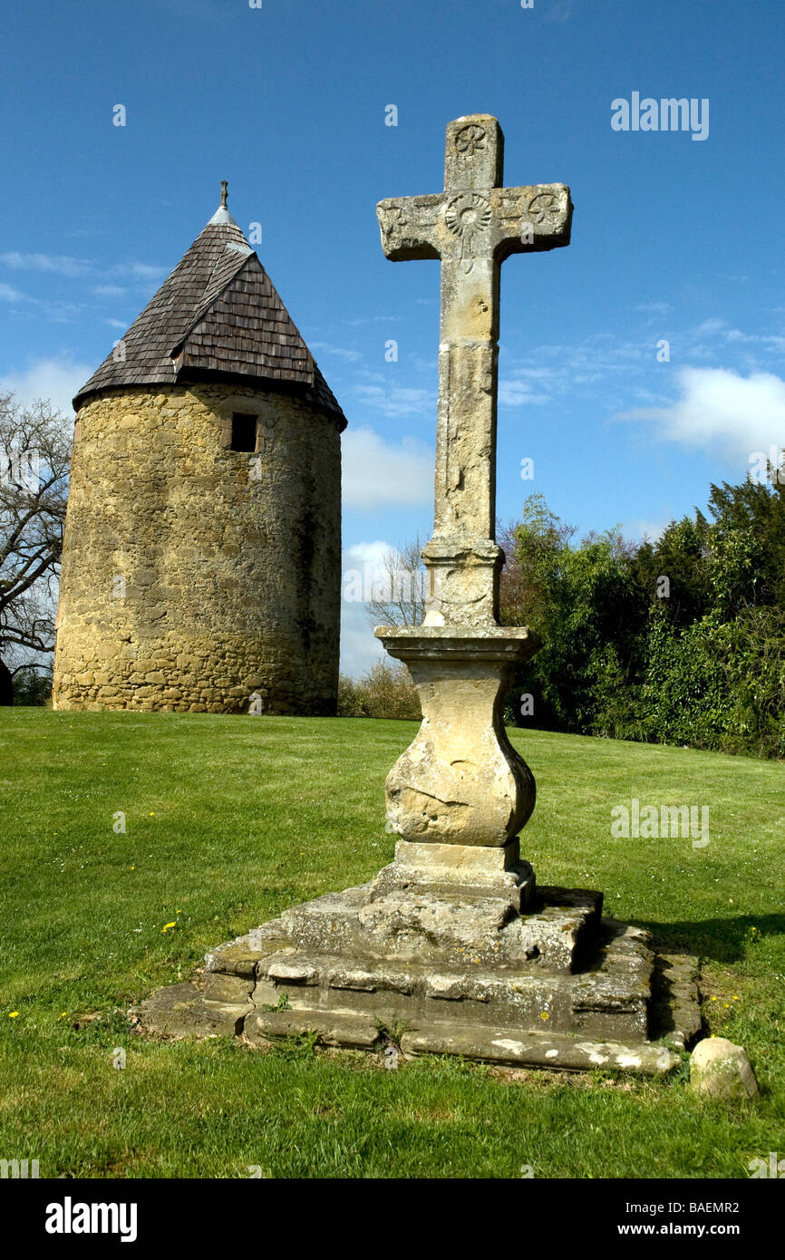 An old stone cross and a preserved mill in the Gascon village of Lupiac ...