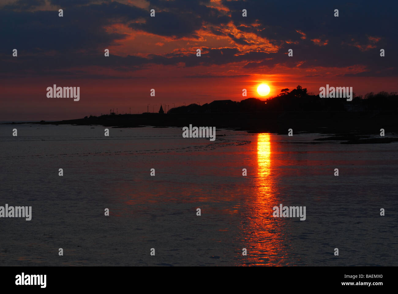 Sunset over Lytham, Lancashire, England with reflections over the sand ...