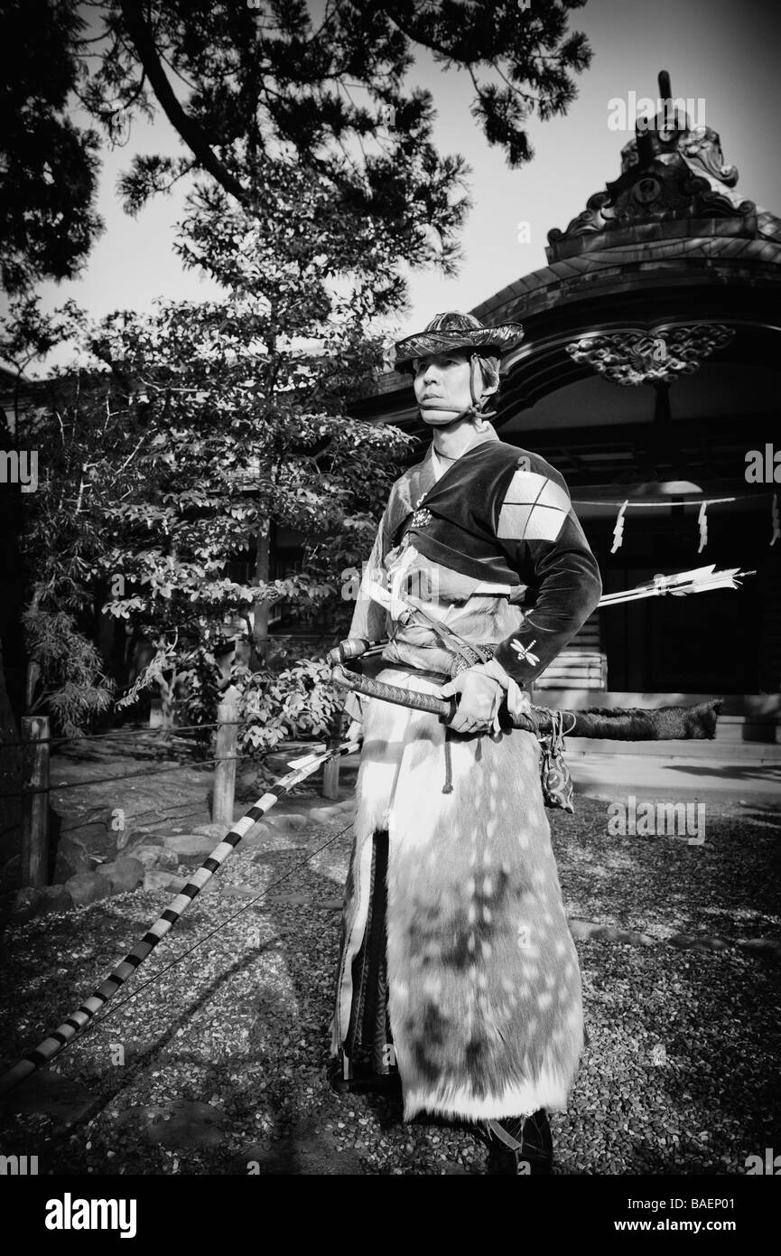 Archer in Samurai Clothing poses in front of the Tsurogaoka Hachimangu ...