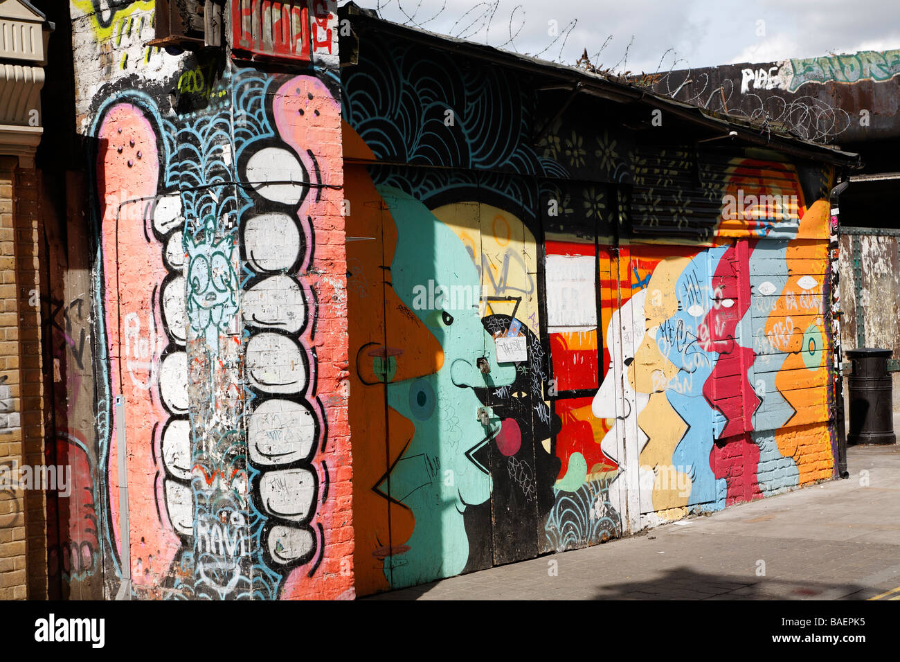 Brightly painted building decorated with graffiti Stock Photo - Alamy