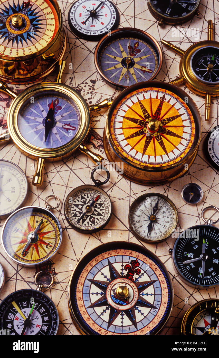 Assorted compasses on old map Stock Photo - Alamy