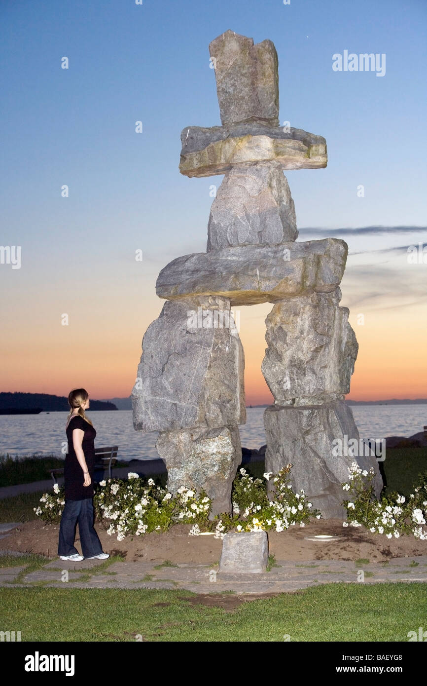 Young woman by Inukshuk at sunset - Vancouver, British Columbia, Canada ...