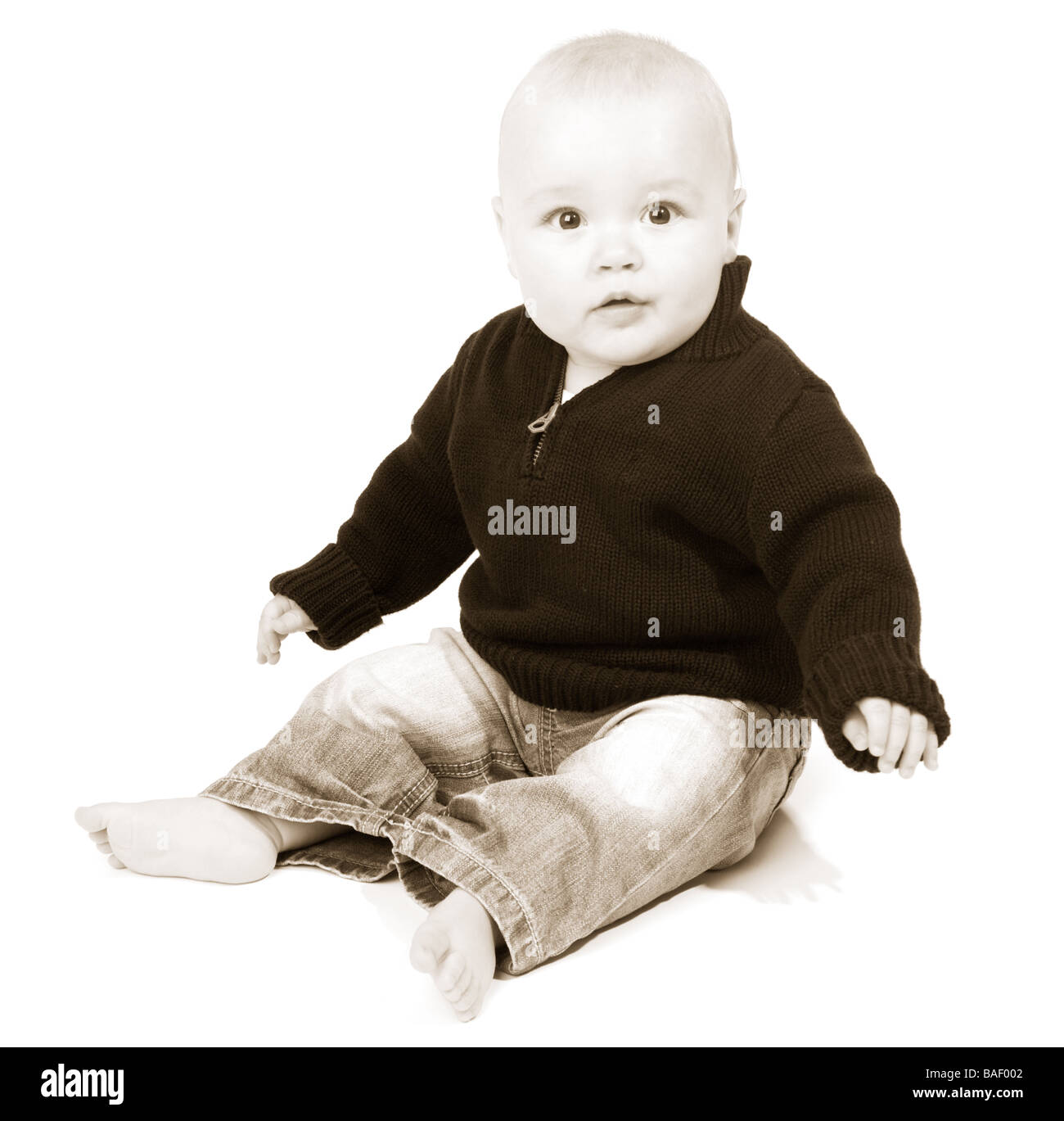 Sepia toned picture of a young boy infant baby sitting on a white ...