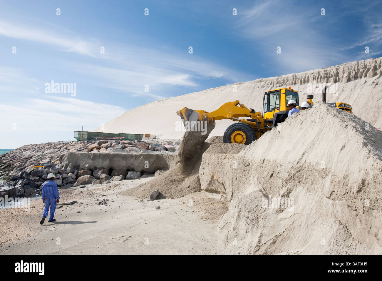 Arab workers working on a reclamation scheme to build another exclusive ...