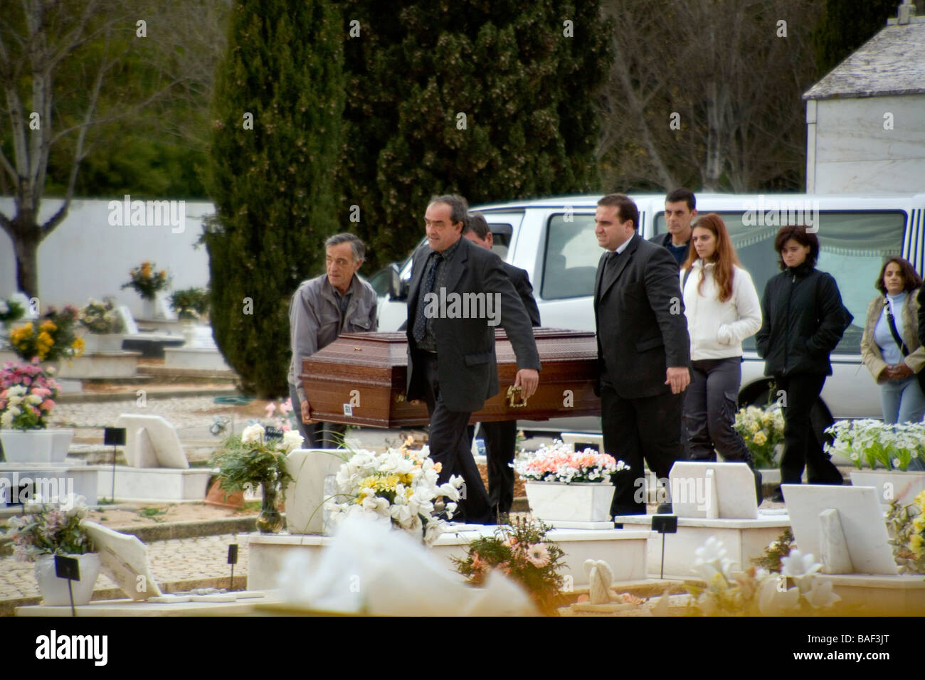 ESTORIL PORTUGAL Pallbearers carrying casket are followed by family ...