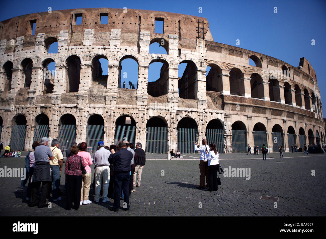 Groups of tourists standing outside the Colosseum in Rome Italy Stock ...