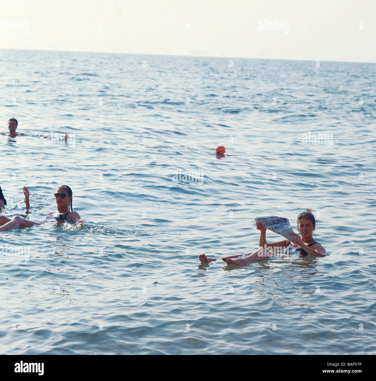 Israel The Dead Sea swimmers floating and reading newspapers Stock ...