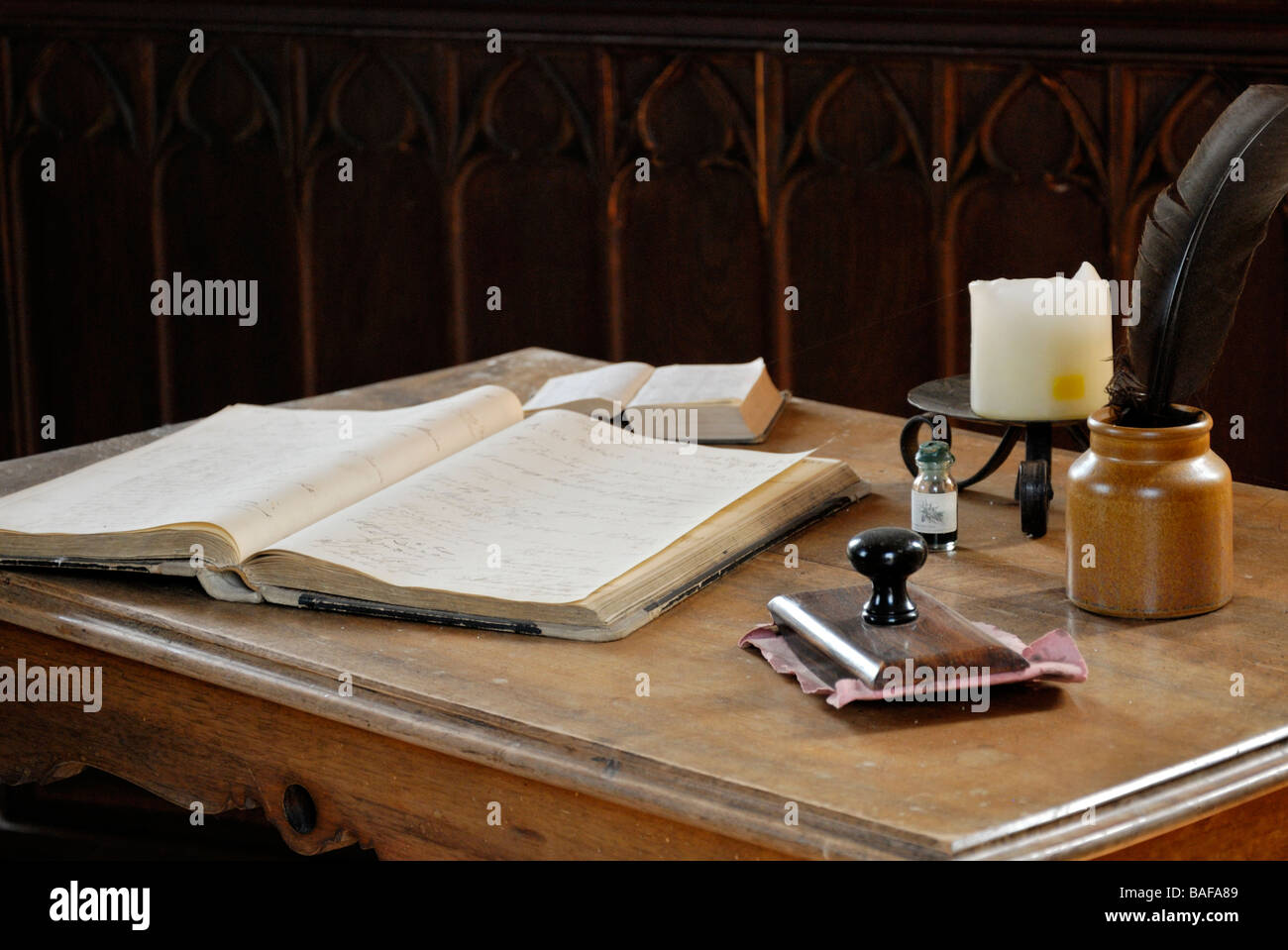 Old-fashioned desk with open hand-written books and ink well, quill ...