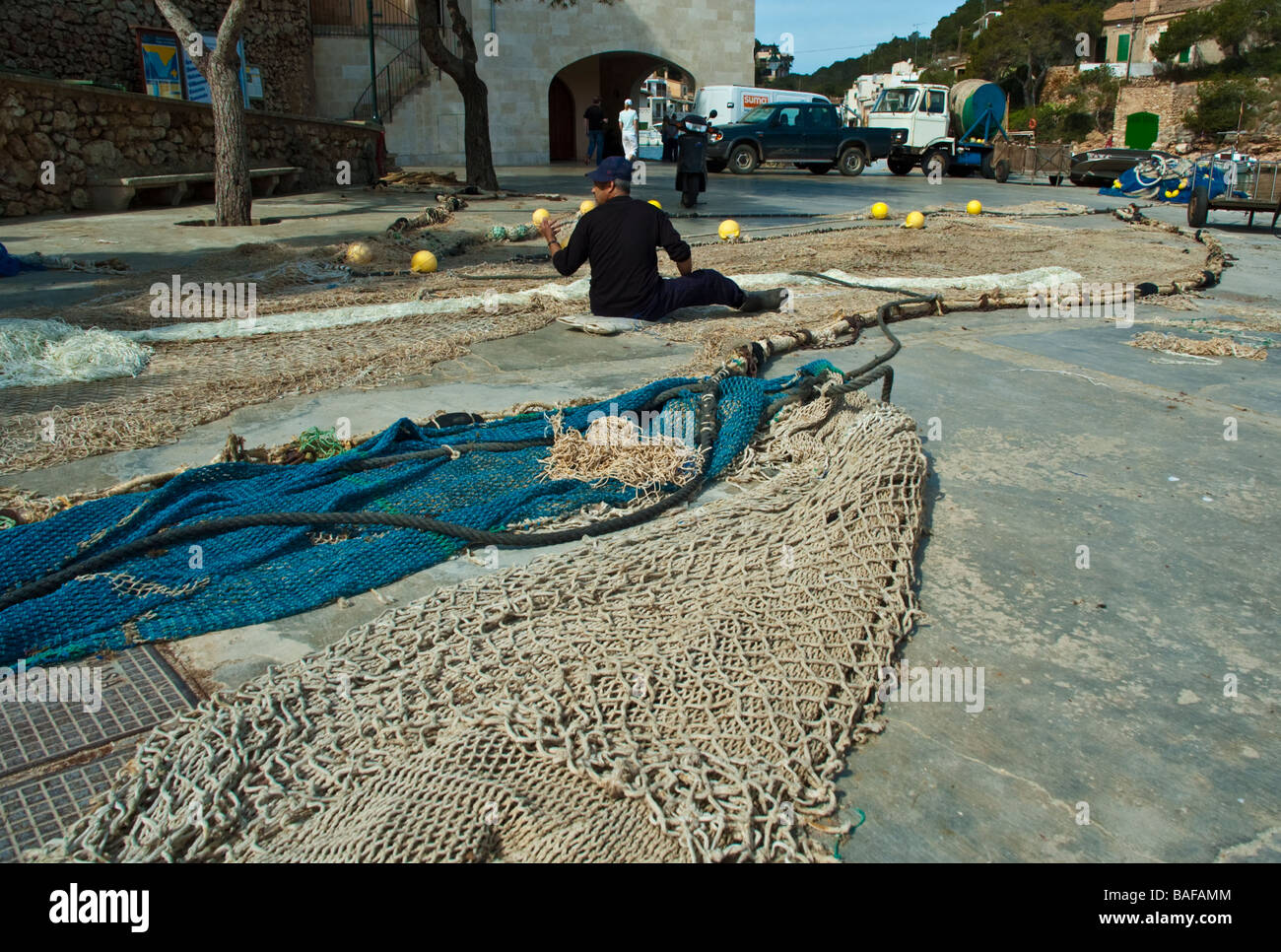 Fisherman mending fishing nets at Cala Figuera Majorca Baleares Spain ...