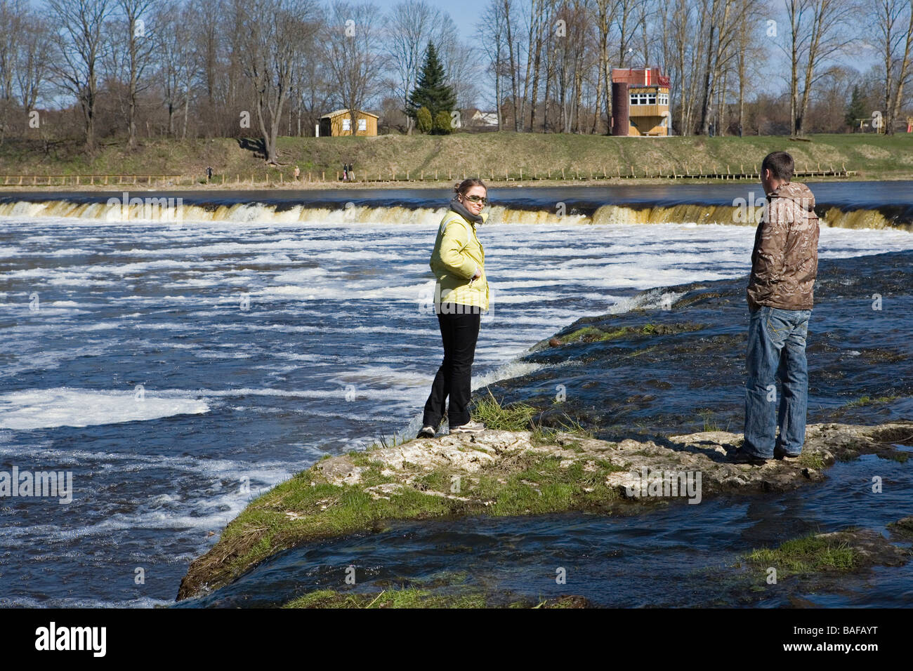 Young visitors at Ventas Rumba waterfalls in Kuldiga city Kurzeme ...