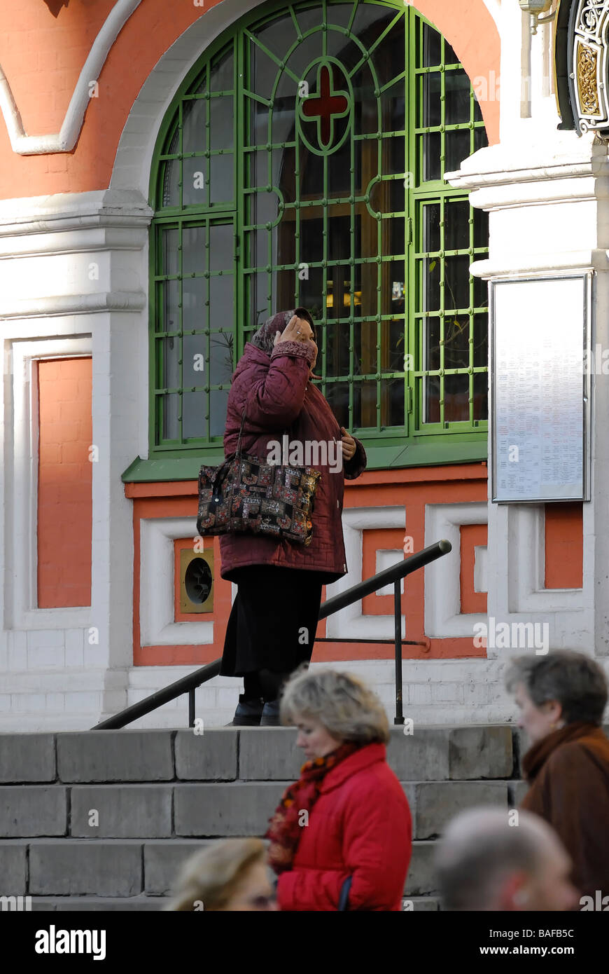 Woman is going enter church Stock Photo - Alamy