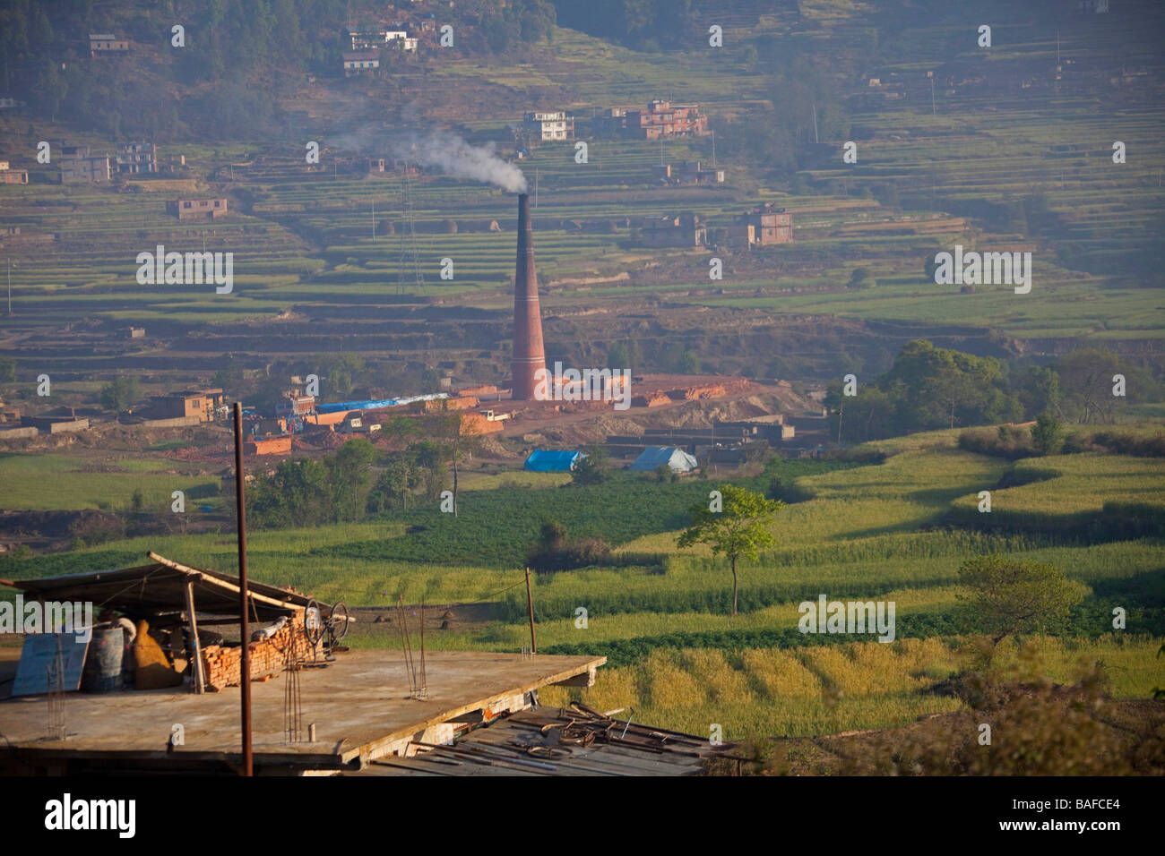 Brick factory with chimney and smoke. Rice fields foreground. Kathmandu ...