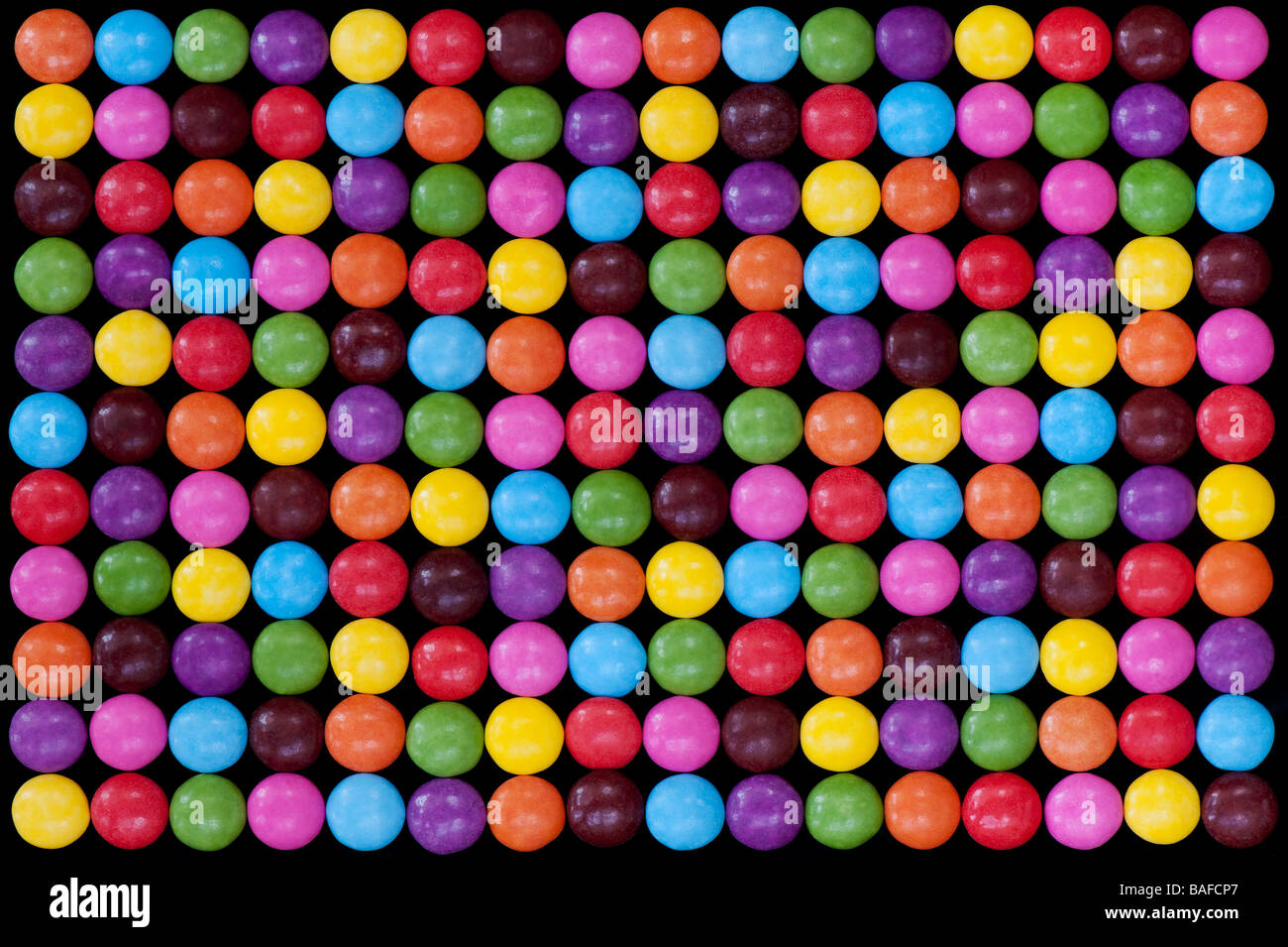 Smarties pattern on black background Stock Photo - Alamy