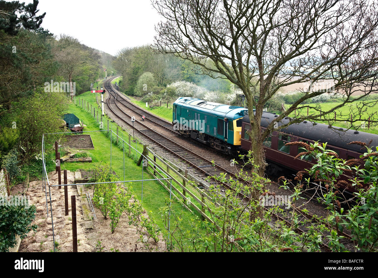 A "Diesel Locomotive" pulls out of "Weybourne Station" on the "North ...