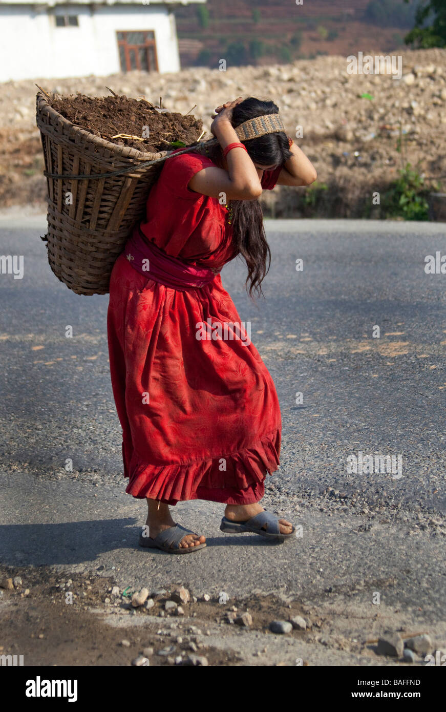 Woman Carrying Large Basket Of Wood On Her Head Farming In Nepal