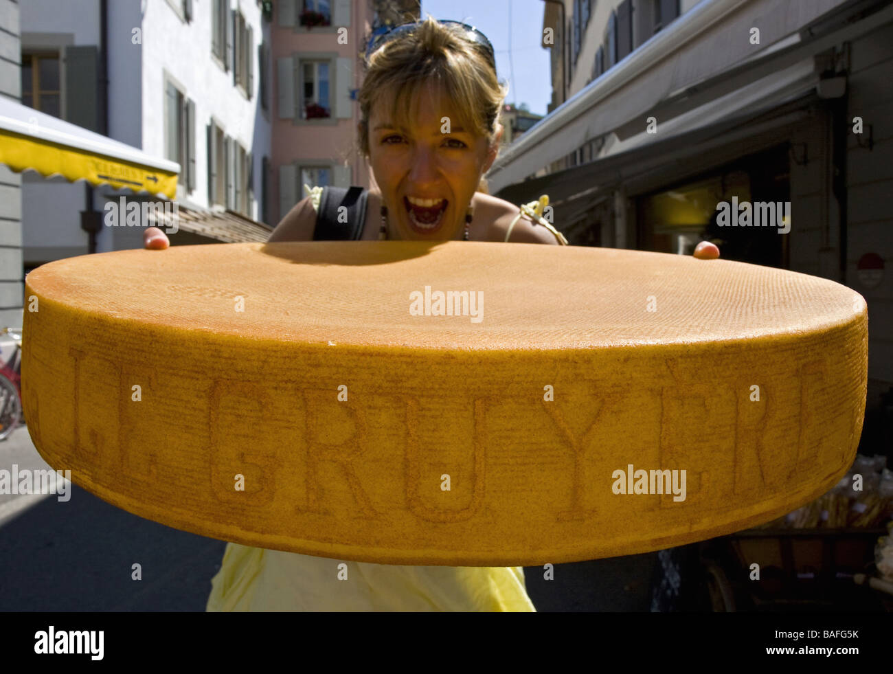 Woman eating Gruyere cheese Stock Photo - Alamy