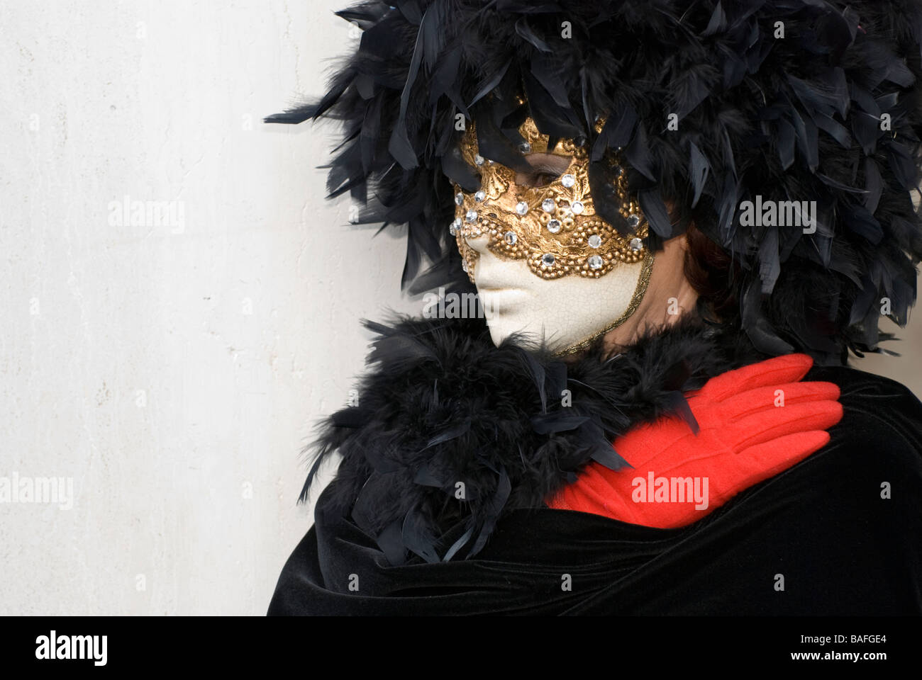Single girl in a venetian carnival disguise with a gold mask black ...